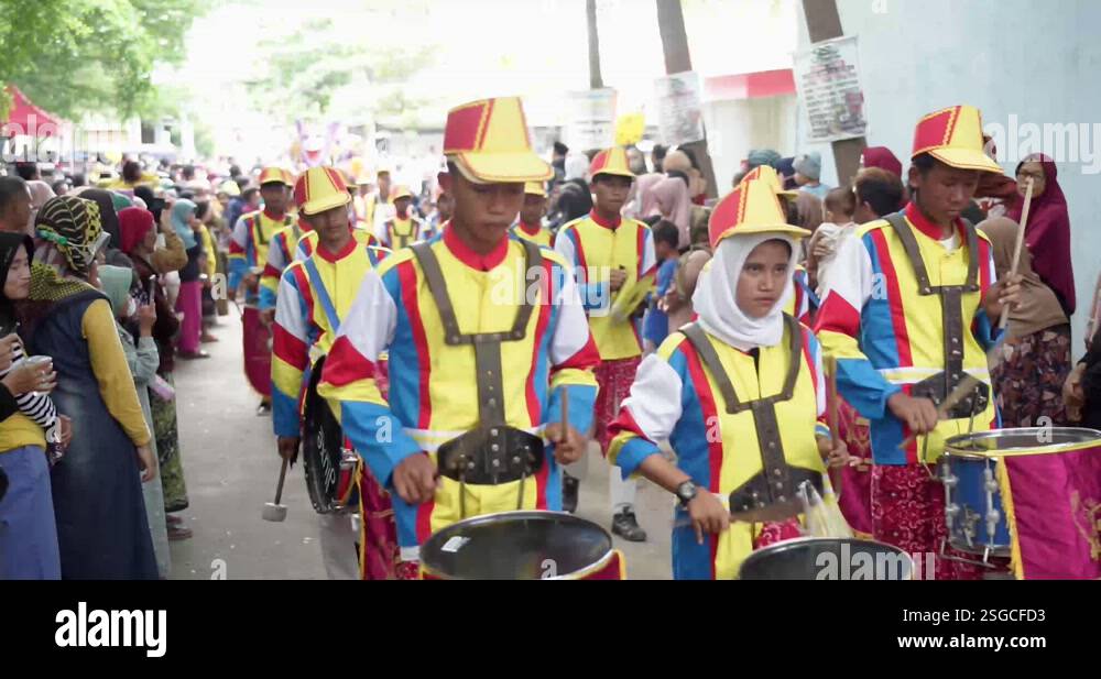Dancers dance and walk to the music of the marching band at an arts and ...