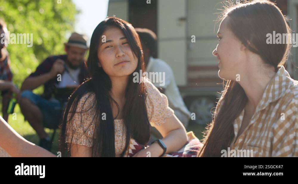 A team of girls get together for an outdoor picnic in the fresh air ...
