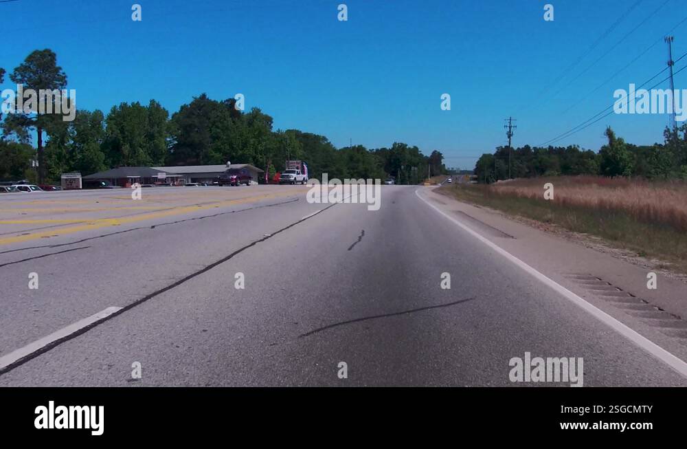 POV FPV driving clear blue sky traffic turning onto a highway and ...