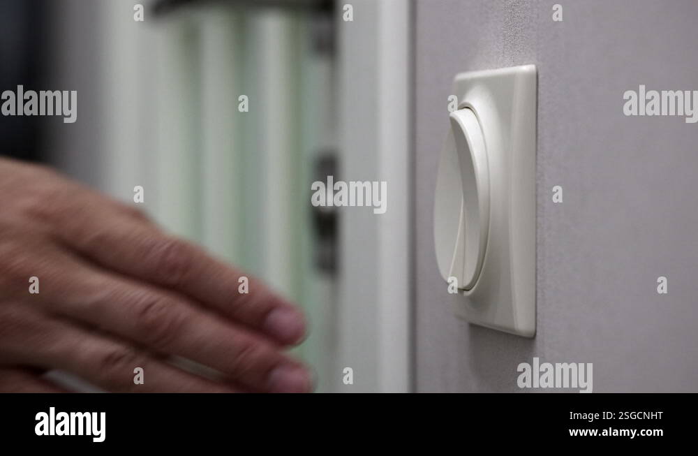 Light Switch Off The Wall. Turn Off The Light Switch. Hand On The ...