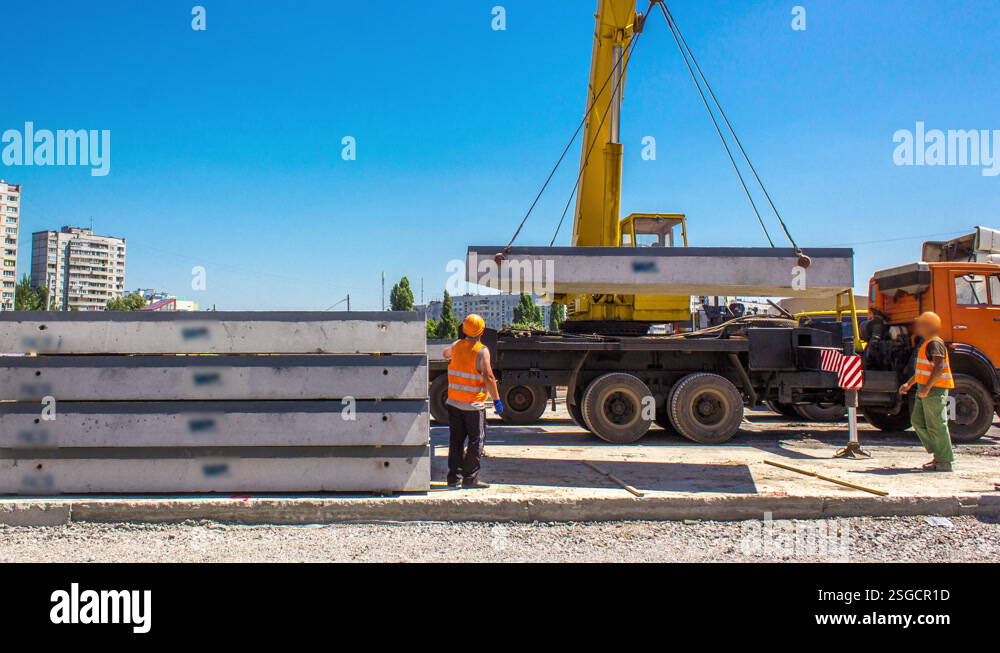 Unloading concrete plates by crane at road construction site timelapse ...