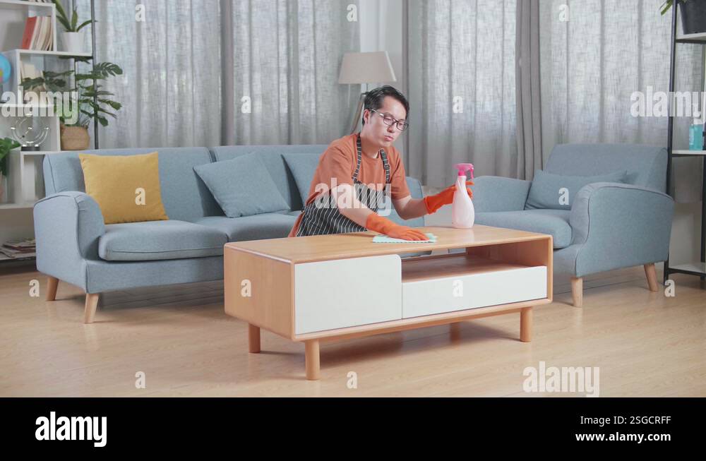 Upset Asian Male Housekeeper With An Apron Crying While Cleaning The ...