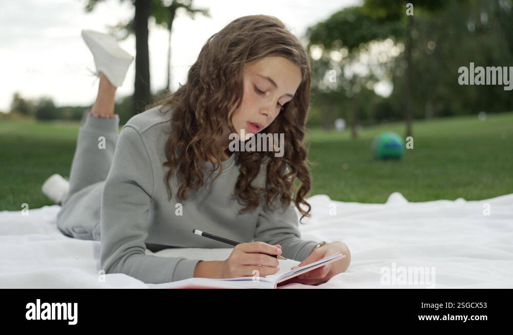 A teenage girl from Europe is writing in a notebook Stock Video Footage ...