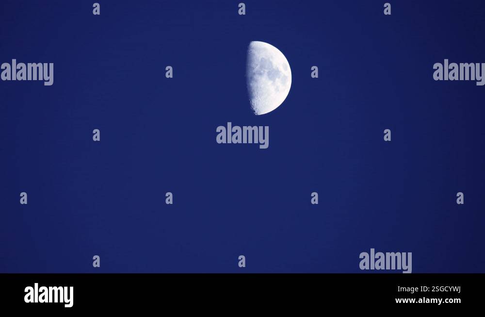A time-lapse of the moon going across the pale blue of the evening sky ...