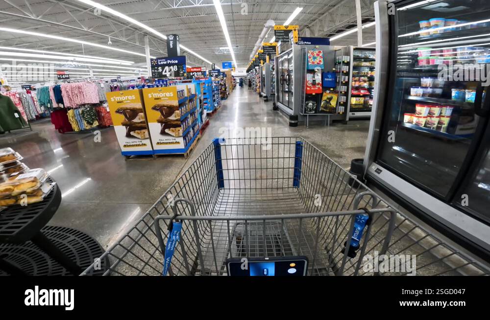 POV while pushing a cart into Walmart freezer section from the main ...
