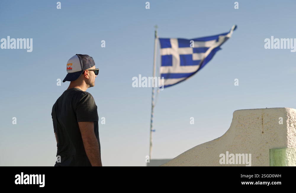 One man stands next to a waving Greek flag Stock Video Footage - Alamy