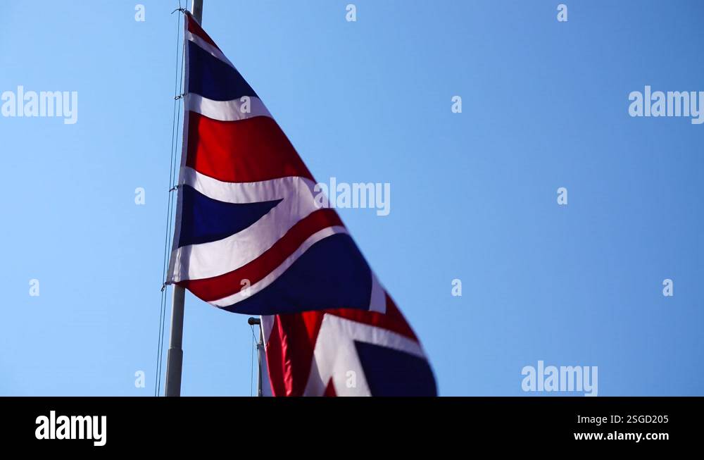 Flag of Great Britain against the blue sky Stock Video Footage - Alamy