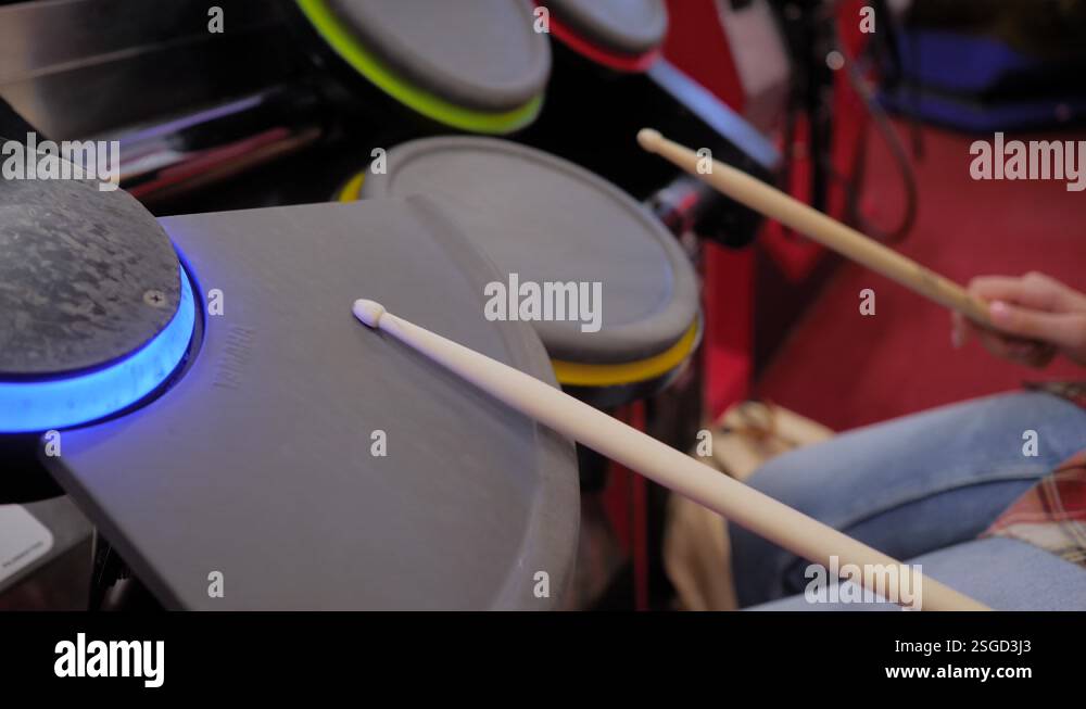 Woman gamer playing retro rhythm drum kits set arcade machine: close up ...