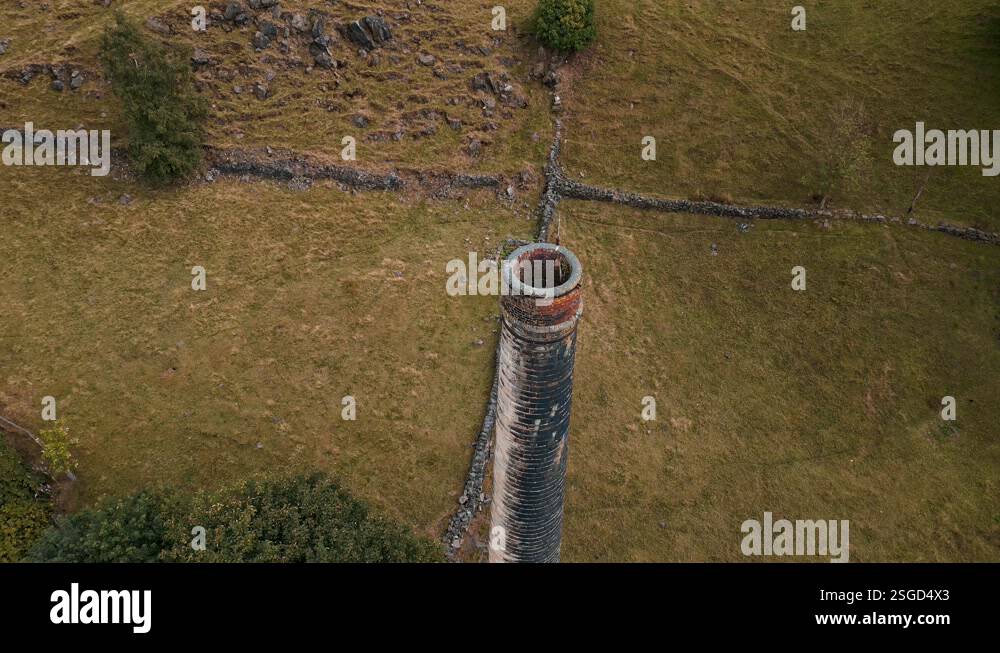 Drone footage of a old mill chimney stack, With footage rotating around ...