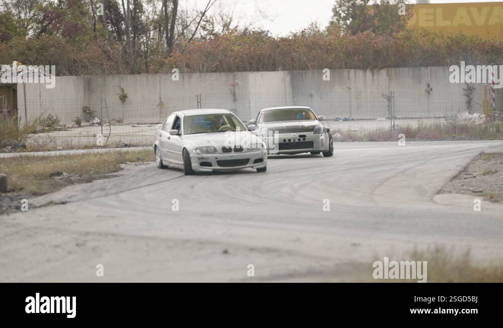Two cars side by side sliding into corner sideways in slow motion 4K ...