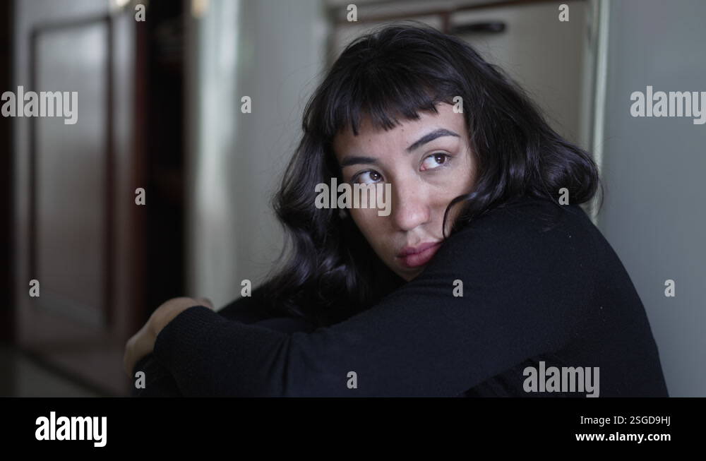 Insecure fearful woman suffering alone at home from anxiety and ...