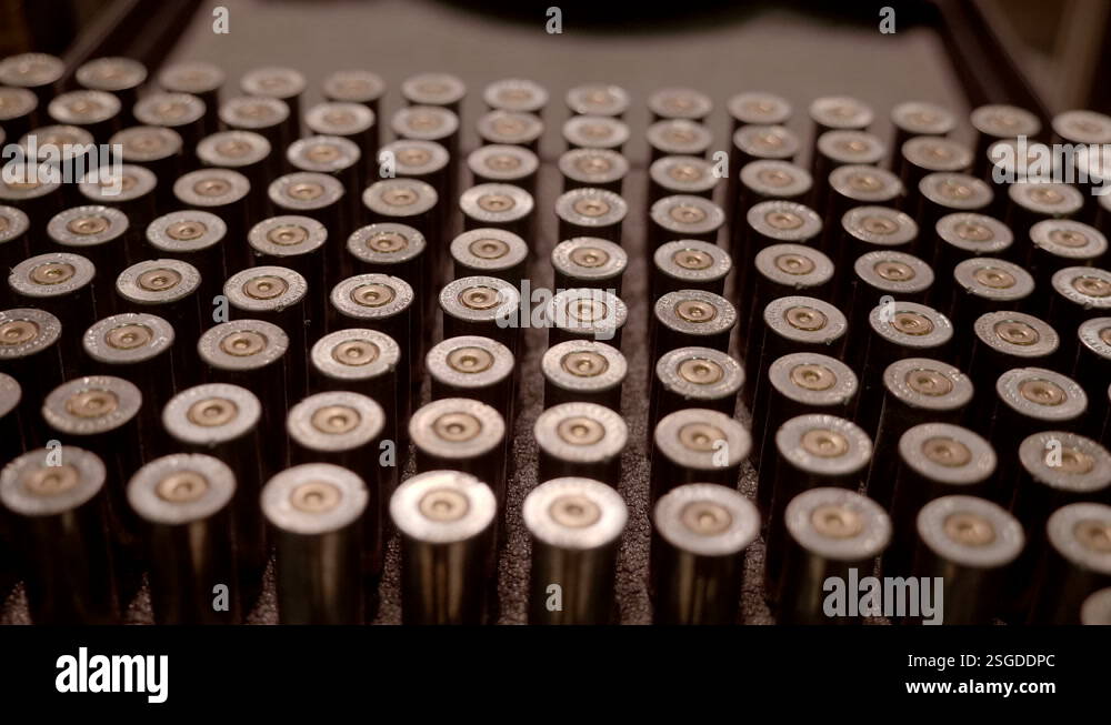 Many rows of used cartridge cases with punched capsules from rifle ...