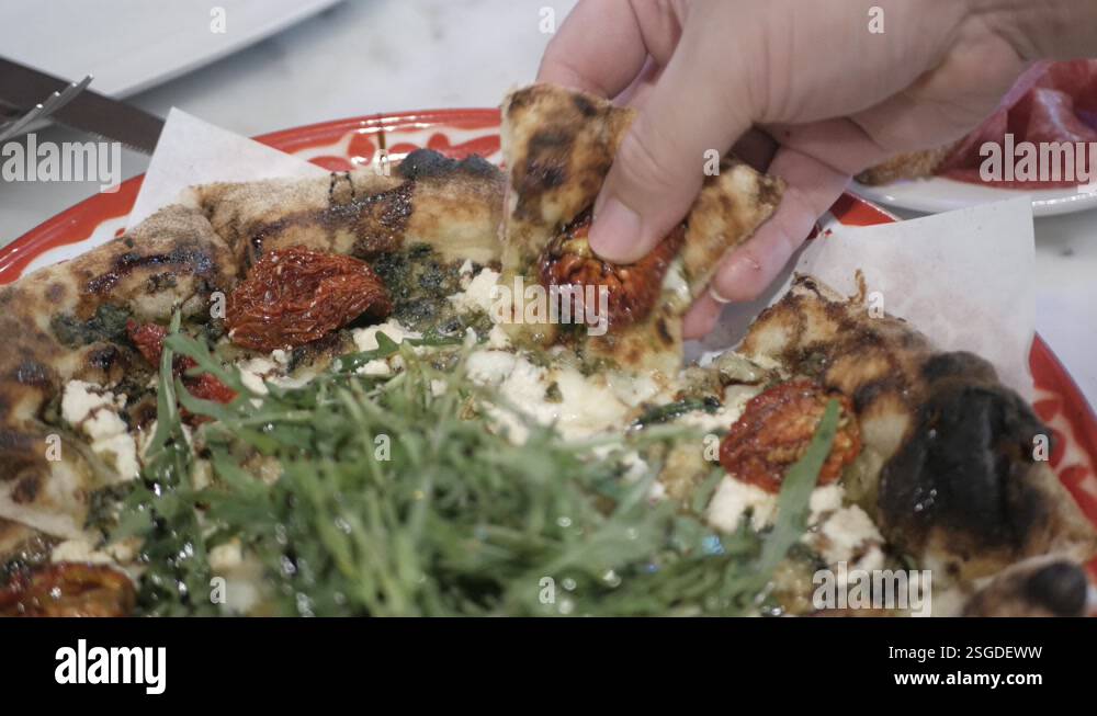 grab pizza from a pan of groumet homemade fresh bake pizza with rocket ...