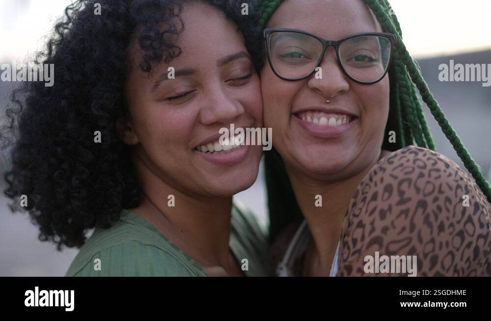 Two young black women faces cheek to cheek. South American adult girls ...