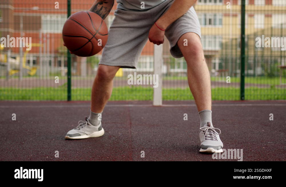 Unrecognizable man basketball player is hitting ball in freestyle on ...