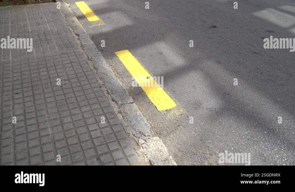 Yellow dashed line on the asphalt road. Road markings. Asphalt dark ...