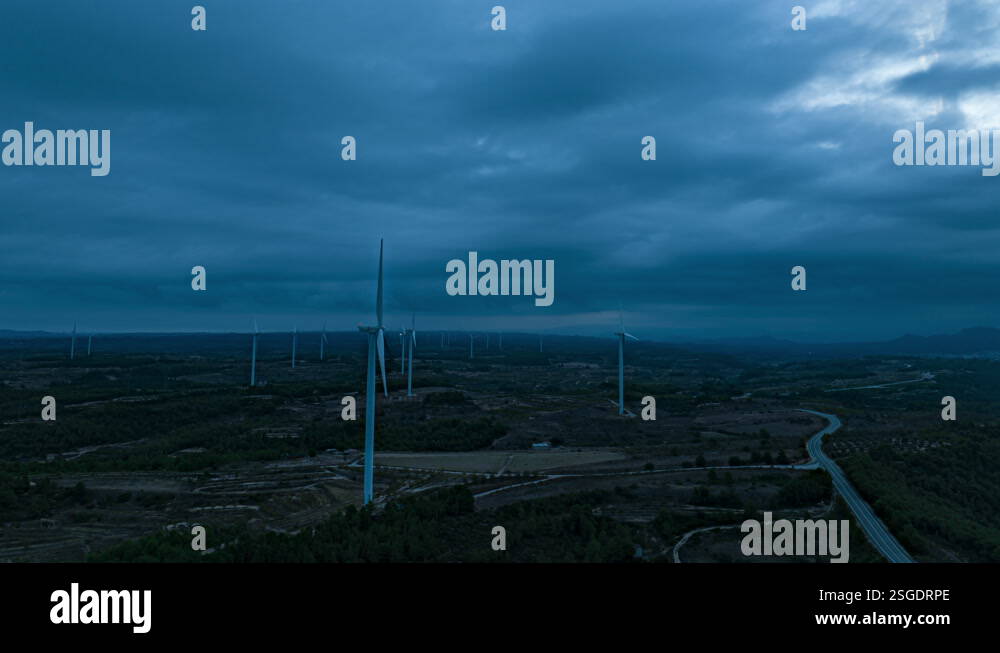 A wind turbine stopping in a dark moody hyperlapse scene, cold blue ...