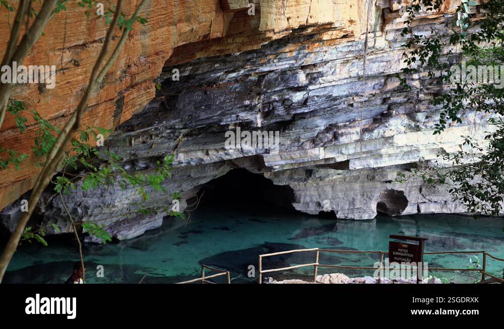 Tilting down wide shot revealing a stunning grey cave grotto with a ...