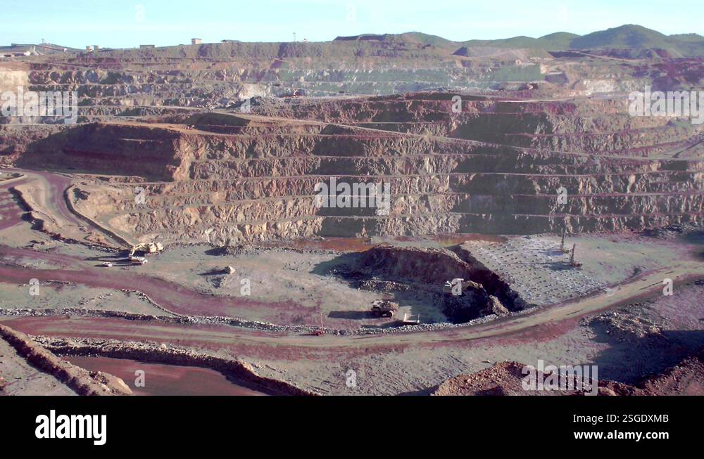 Static shot of Mars like copper open pit mining area where haul trucks ...