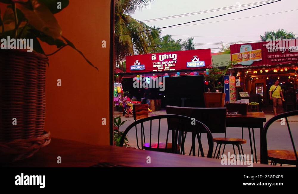 Editorial. Busy street and pub in downtown Siem reap, Cambodia seen ...