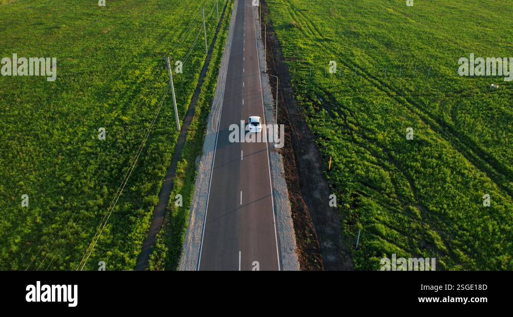 Aerial view of a white car moving along an asphalt road Stock Video ...