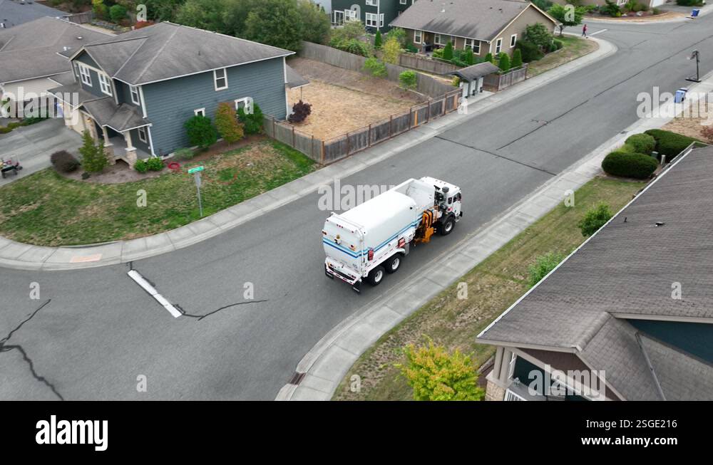 Drone shot following a dump truck as it makes its rounds in an American ...