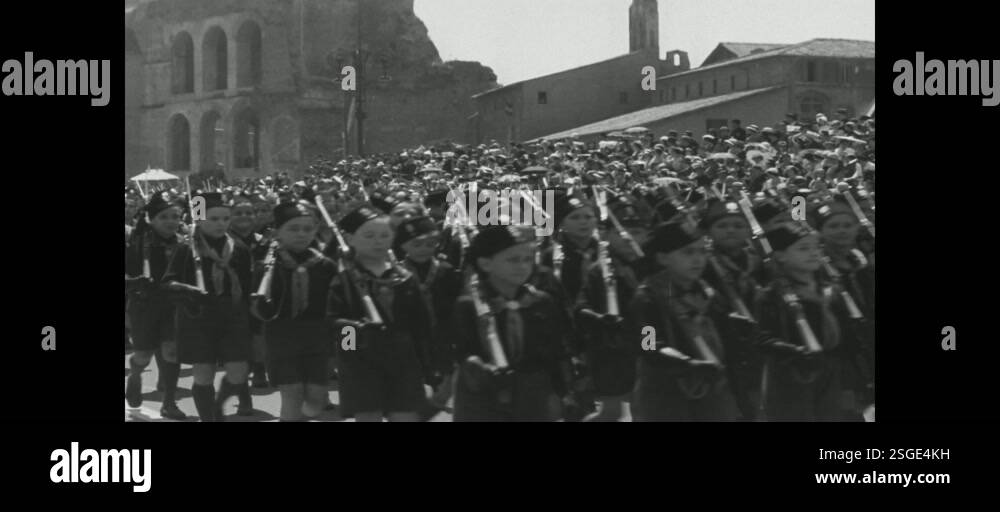 1940s: Military man on horseback. Children with guns marching in front ...