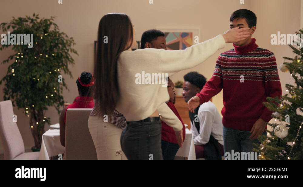 Man and wife greet guests who have come to celebrate Christmas. They ...