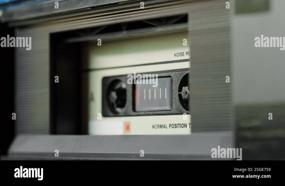 Retro radio tape recorder, audio cassette playing close-up. Listening ...