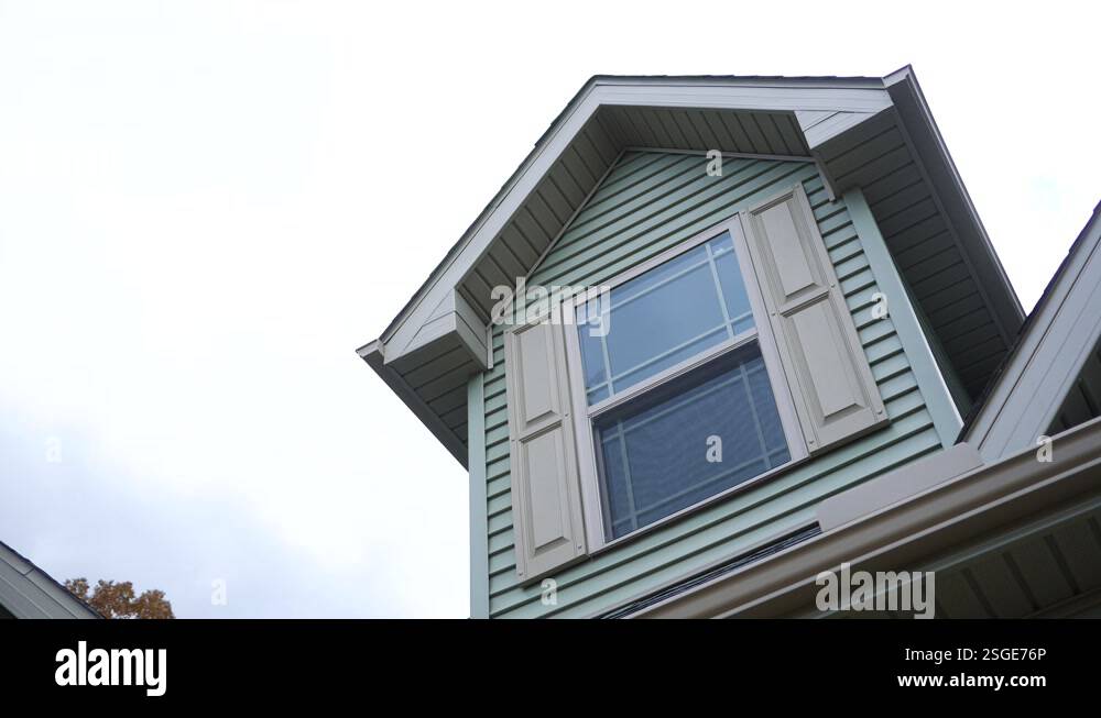 A second story window of modern luxury home during overcast day Stock ...