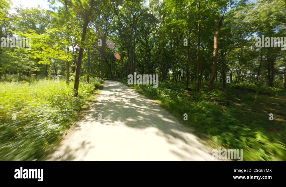 Biking and running on crushed limestone trail path. Sunlight going ...