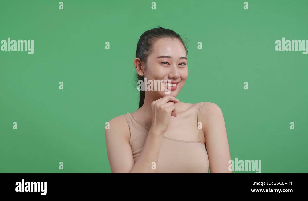 Smiling Beautiful Asian Woman Turning To Camera And Touching Her Face ...