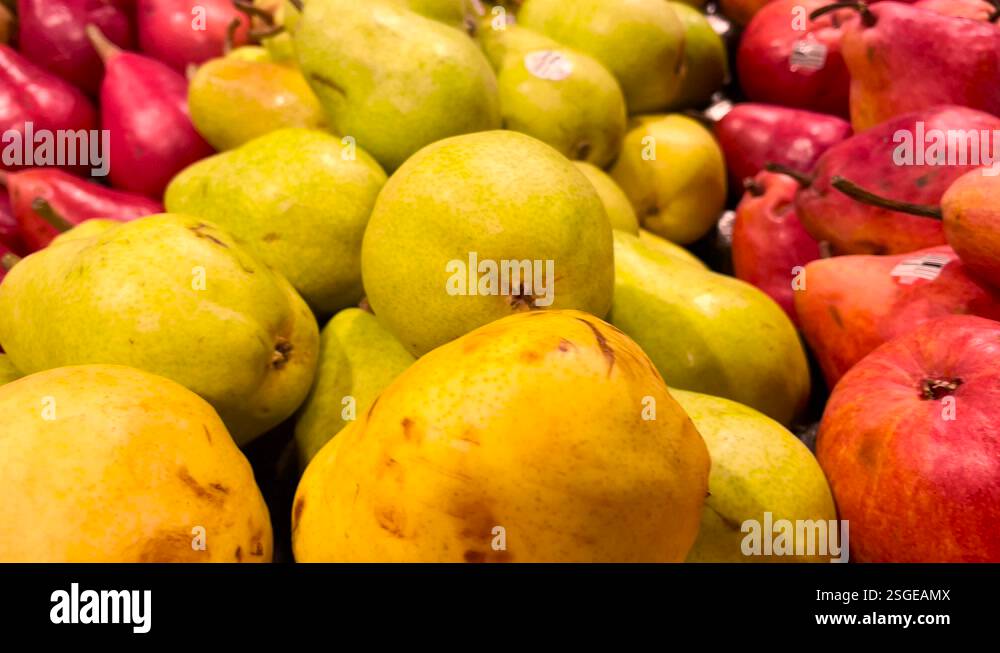 Rows of fresh colorful pears on display in a grocery store Stock Video ...