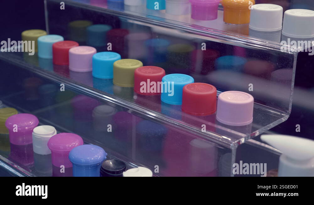 Rows of different new plastic caps of different colors, shapes and ...