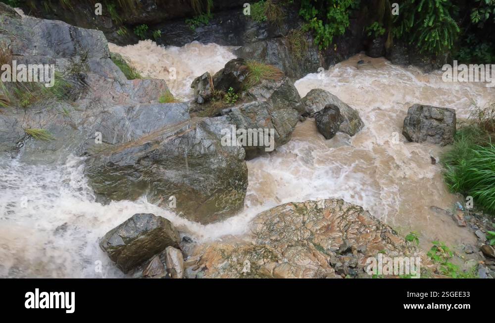 Water raging over the rocks of a waterfalls in the hills of Nepal ...