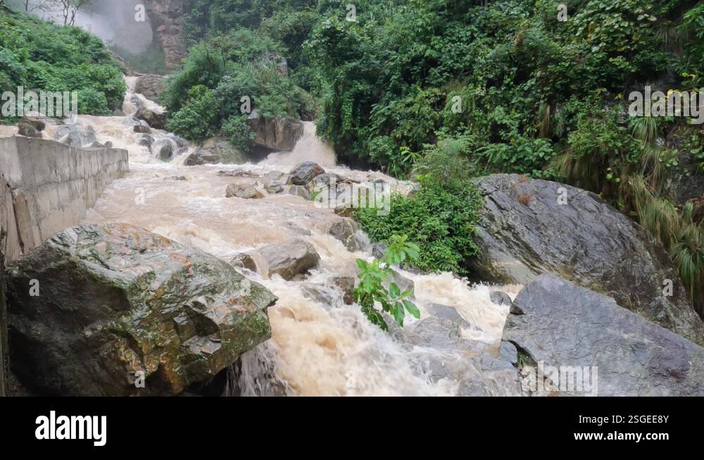 Water raging over the rocks of a waterfalls in the hills of Nepal ...