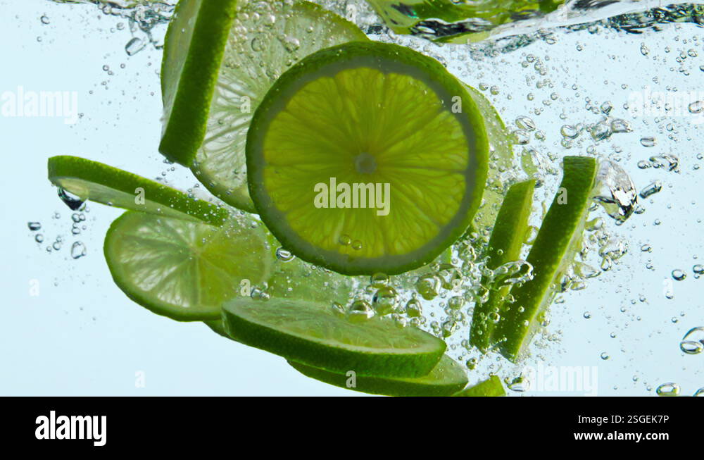 Juicy lime fall water on white background. Citrus floating underwater ...