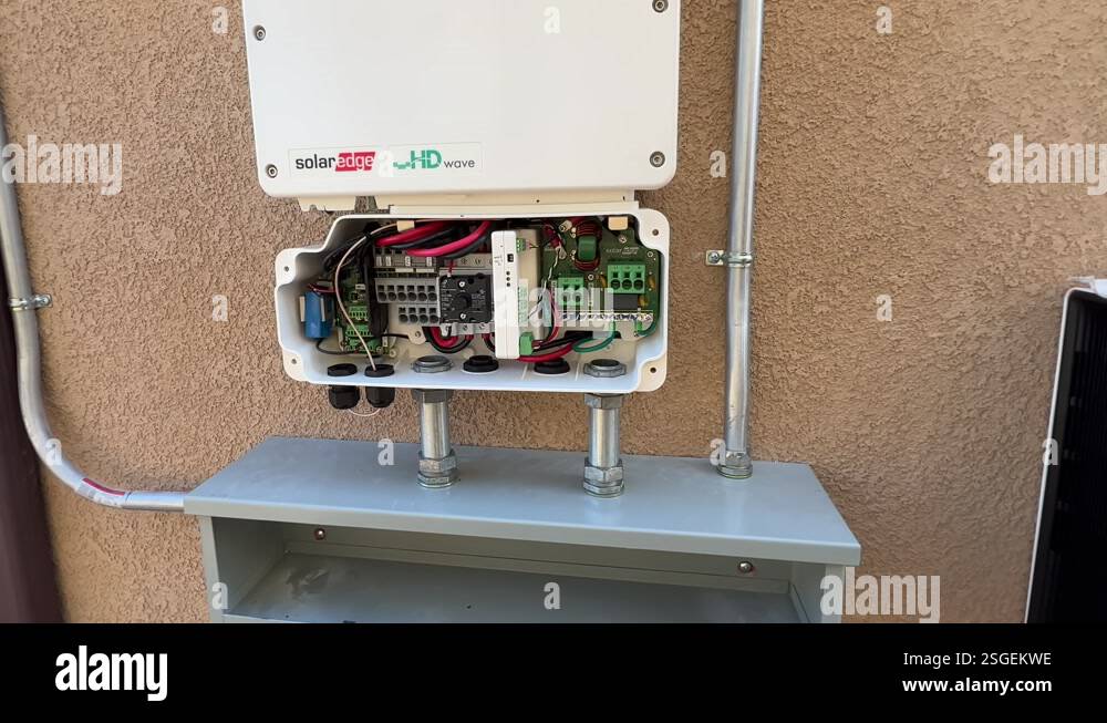 Tracking out shot from Solar Inverter installation outside of a house ...