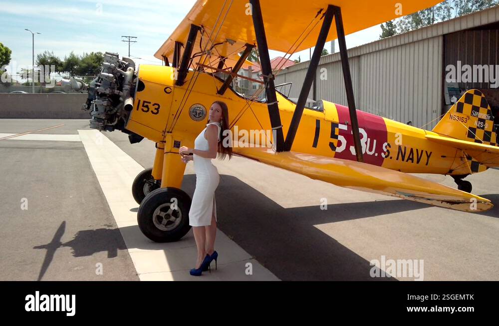 Female Model Wearing Slim White Dress Standing Next To Classing Boeing ...