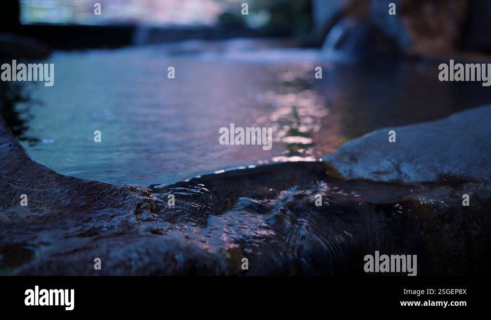 Japanese onsen - water overflowing from stone bath at natural hot ...