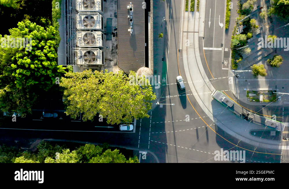 Modern Melbourne city intersection with Tram and vehicles all moving ...