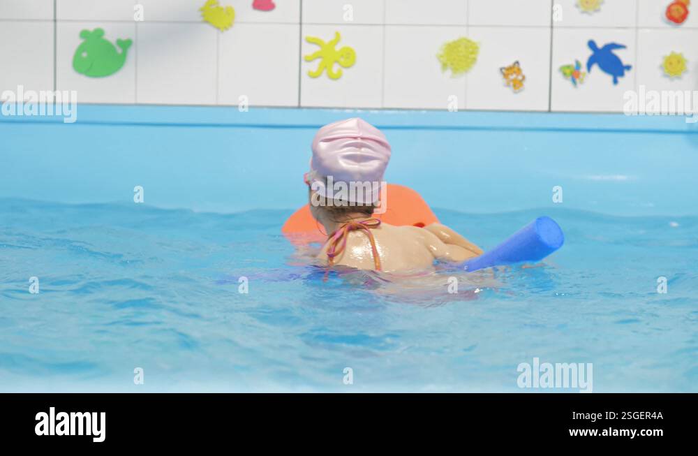 Individual swimming lesson with a personal trainer in an indoor pool ...