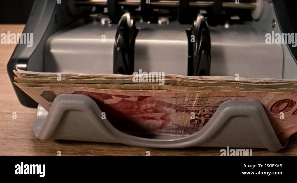 Money counting equipment with many banknotes. Currency exchange ...