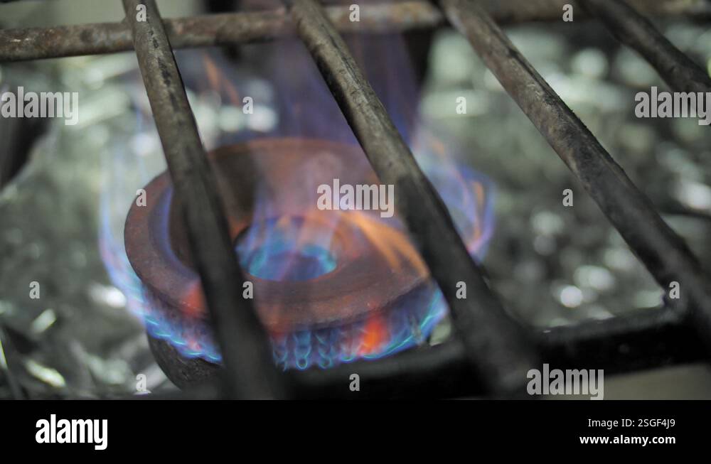 Igniting gas stove with burner and placing metal pot on it, close up ...