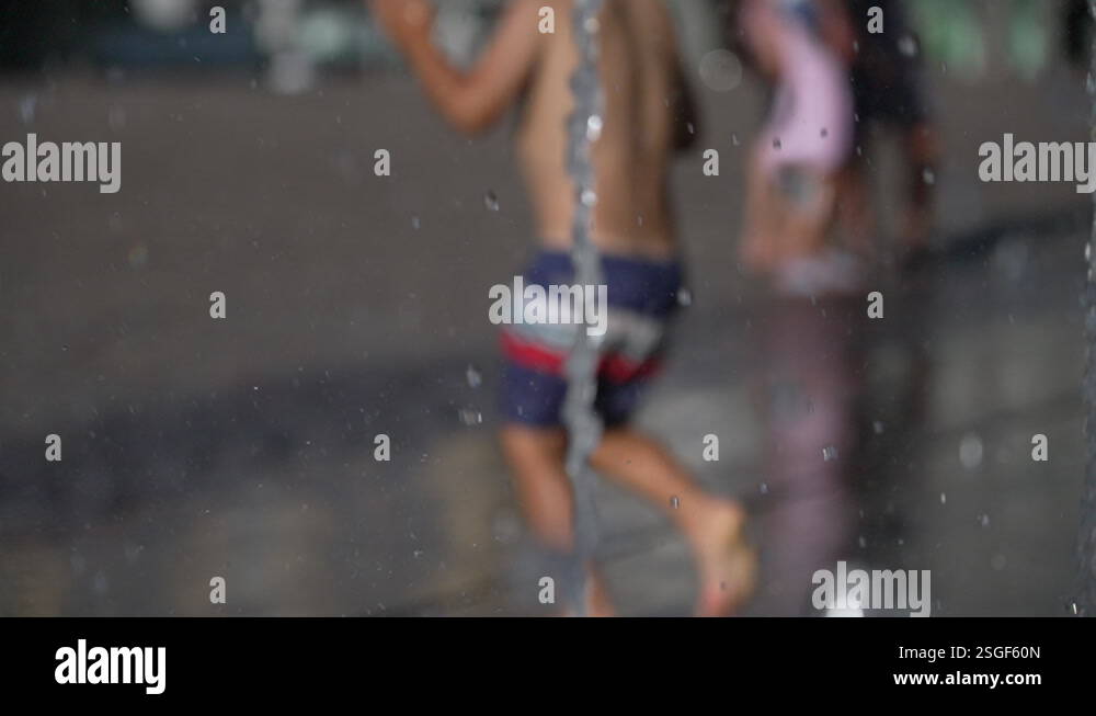 Water park jet droplets falling in super slow motion with children ...