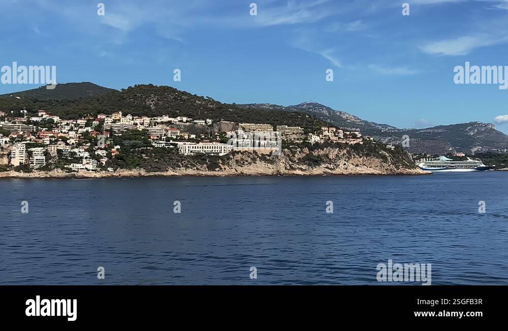 Panning view from open sea of cruise ship moored in port of Nice in ...