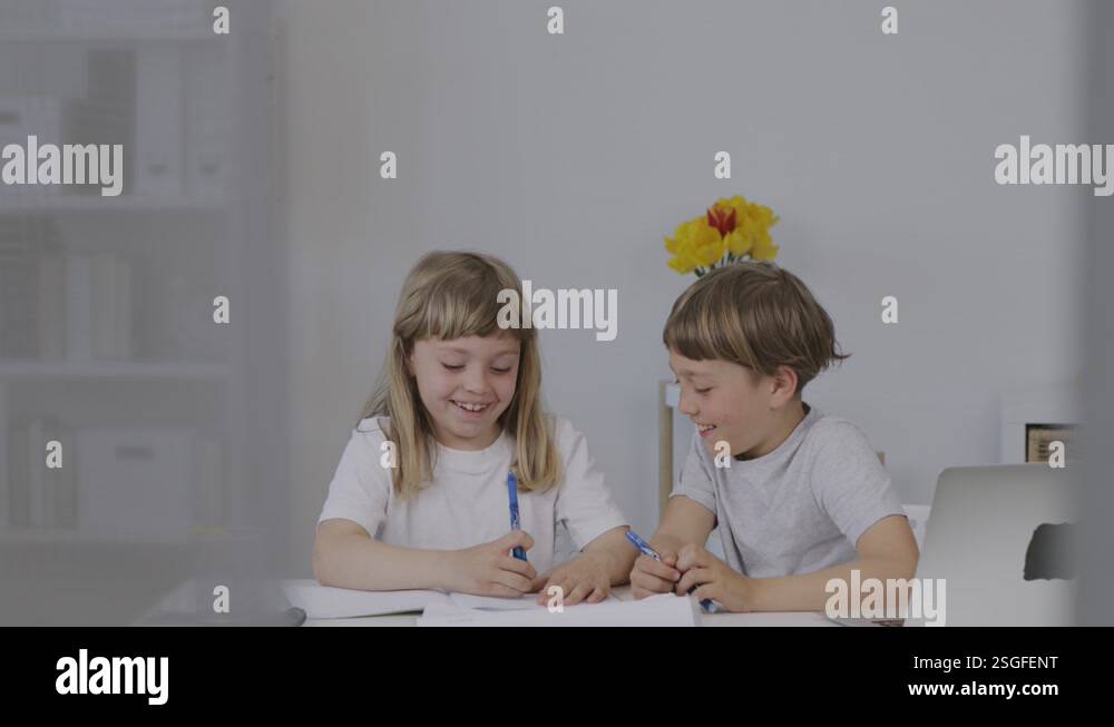 Brother helps his younger sister to make her homework Stock Video ...
