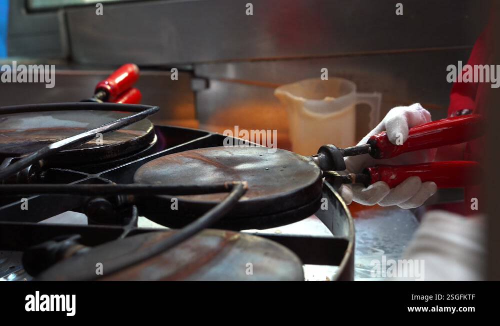 Traditional method of making ice cream waffle cone, cast iron making ...