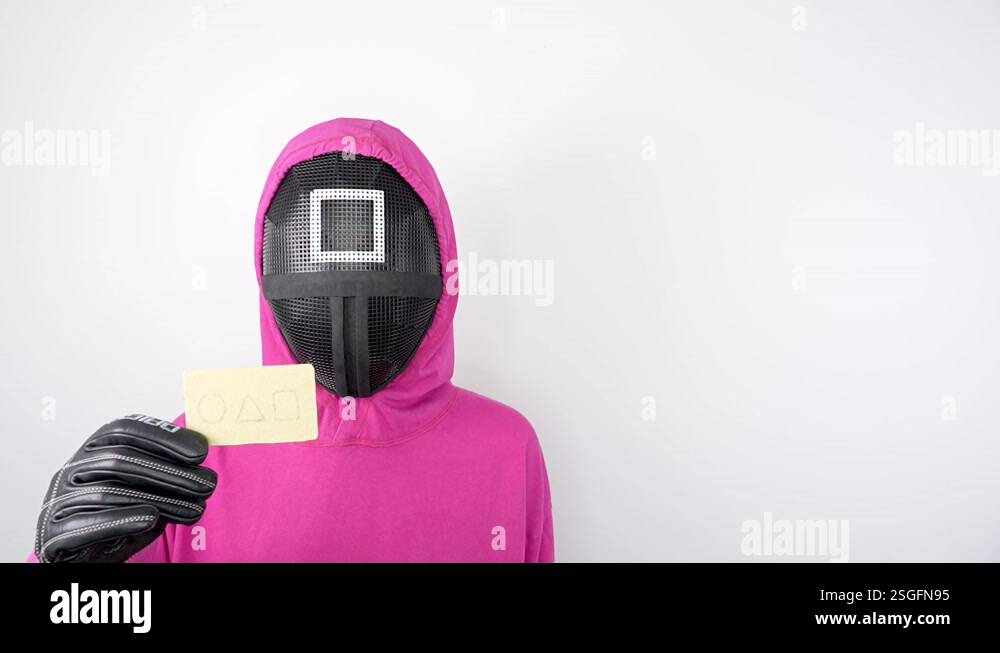 Squid Game pink guard shows the invitation card and shoot with hand gun ...