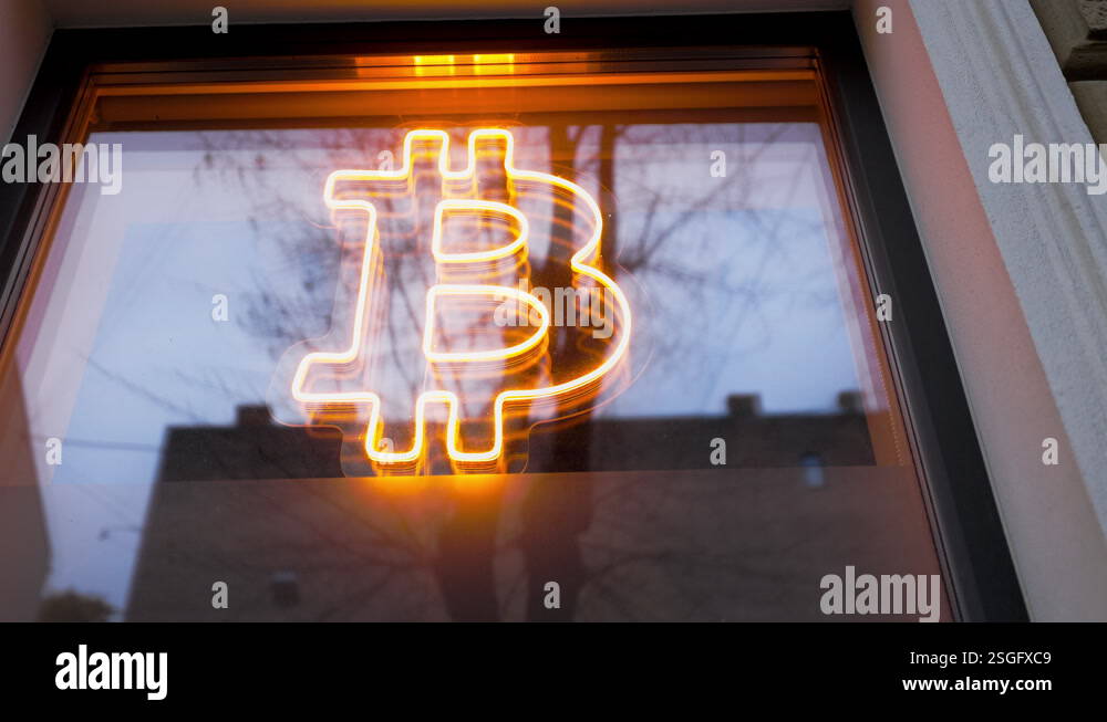 Bright BITCOIN logo on a reflective window with a moody background ...